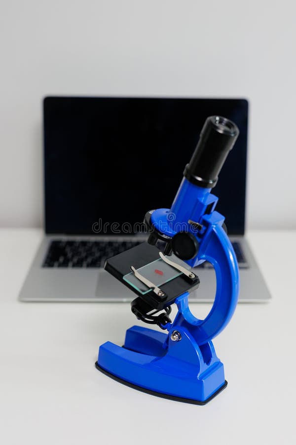 Computer and Blue Microscope on White Table Stock Photo - Image of ...