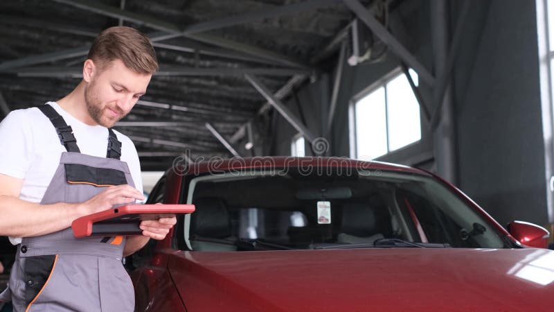 Computer Diagnostics of the Car. European Car Mechanic Holds a Digital ...