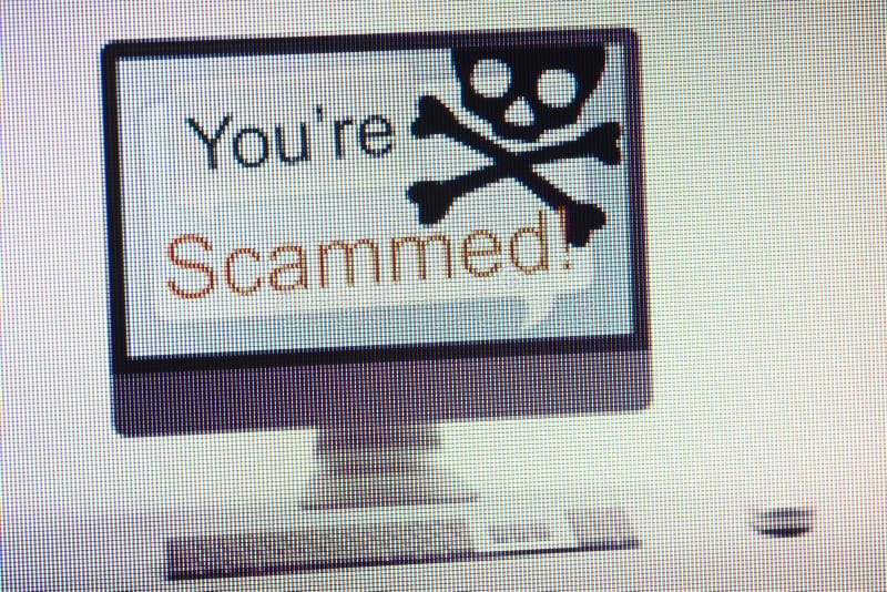Computer Displaying Internet Fraud and Scam Warning on Screen Stock ...