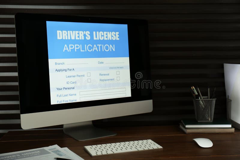 Computer with Driver`s License Application Form on Table in Office ...