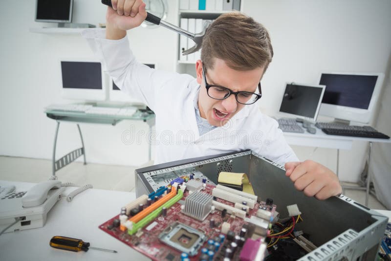 Computer Engineer Holding Hammer Over Broken Console Stock Photos ...