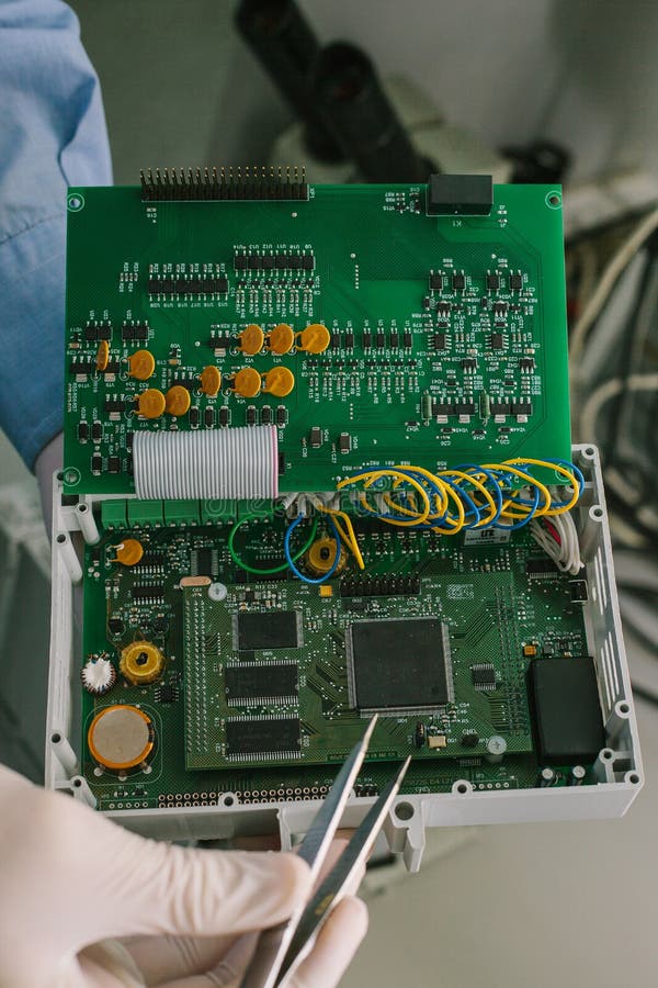 Computer Expert Professional Technician Examining Board Computer in a ...