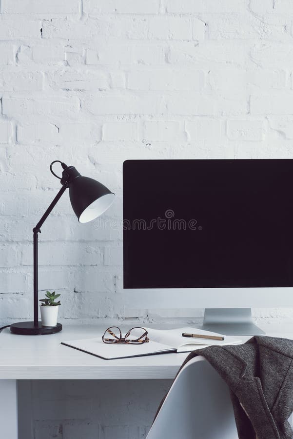 Computer and Glasses on Notebook on Table in Modern Office Stock Photo ...