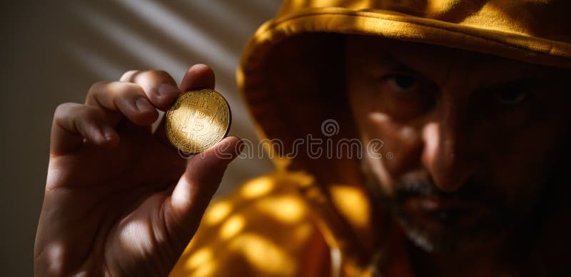 Computer Hacker and Cryptocurrency Scammer in Golden Yellow Hooded ...