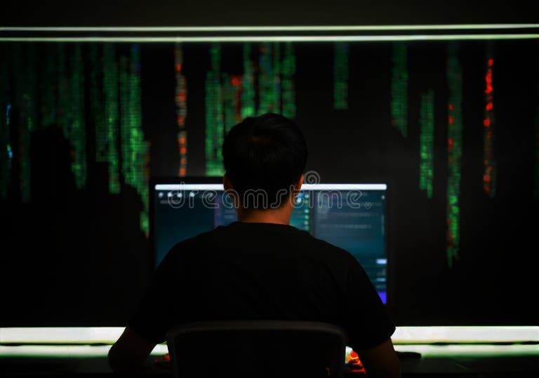 Computer Hacker Operating Computer System in a Dark Room Stock ...