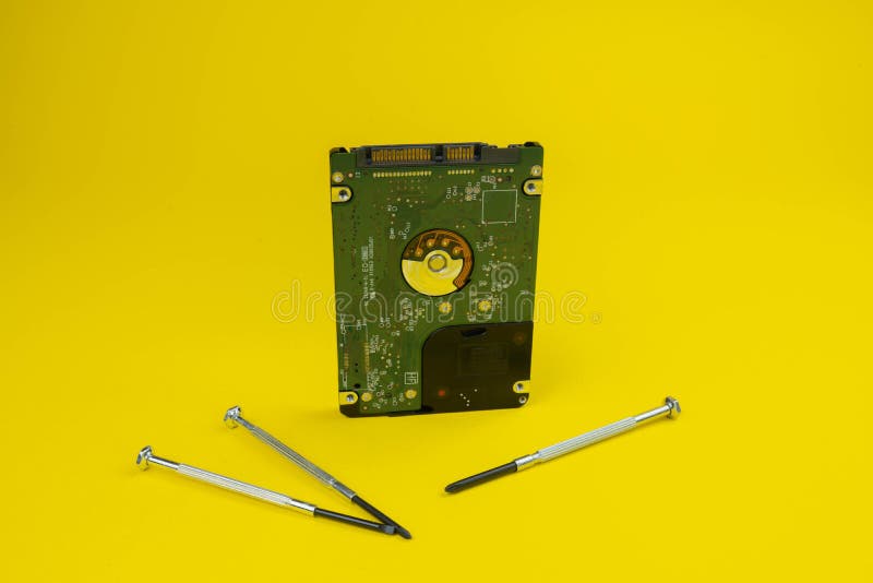 Computer Hard Disk Drive Isolated on Yellow with a Screwdrivers Stock ...