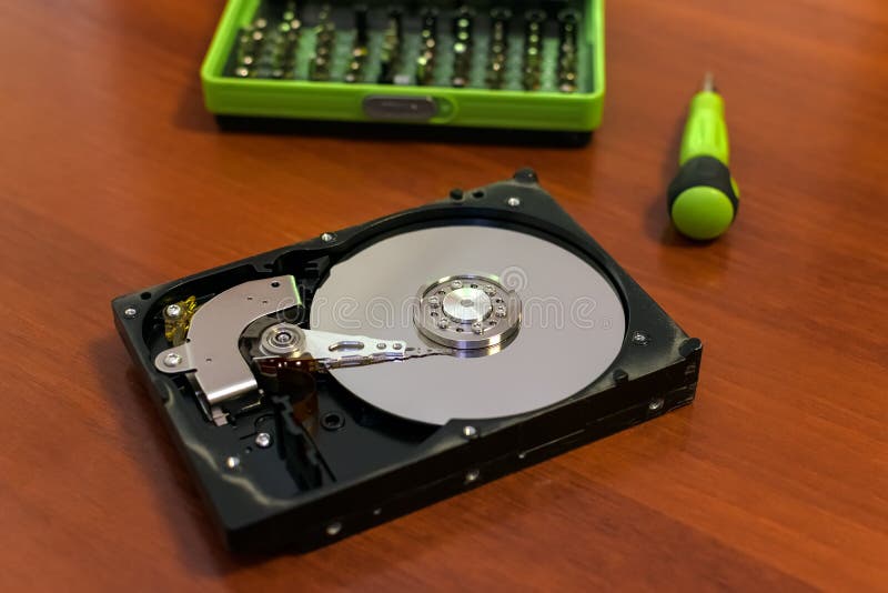 A Computer Hard Drive without a Lid is Lying on the Table in Repair ...
