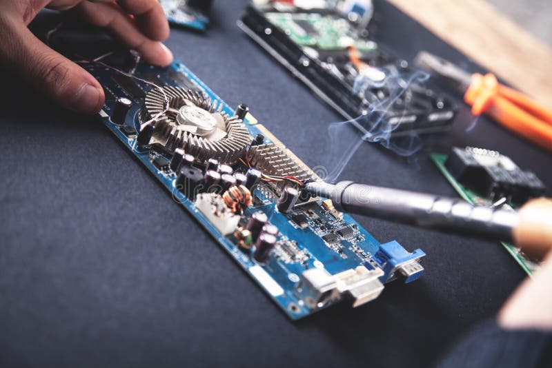 Computer Hardware Engineering. Engineer Soldering Computer Motherboard ...