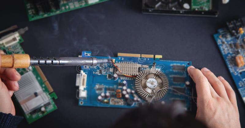 Computer Hardware Engineering. Engineer Soldering Computer Motherboard ...