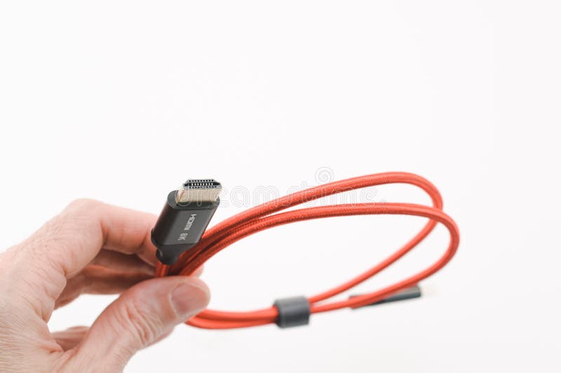 Image with Hand Holding Compuer Cables and Wires on a White Surface ...