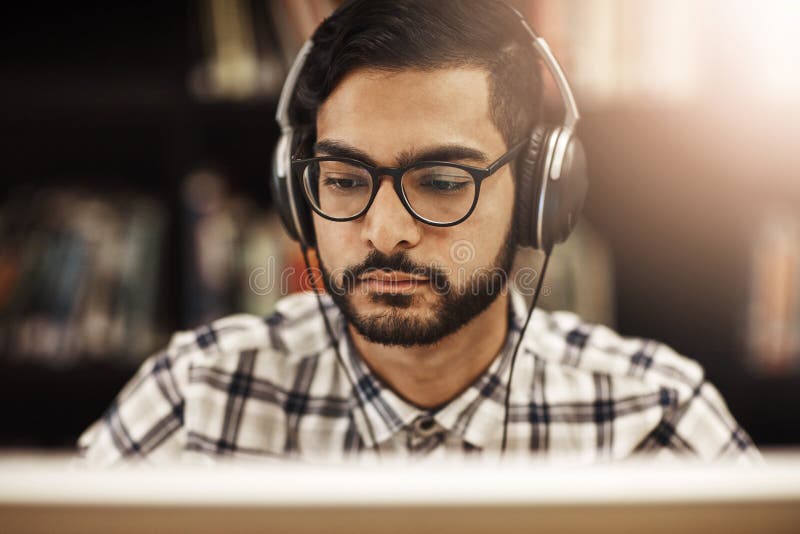 Computer, Headphones and Indian Man in Library for Research, Elearning ...