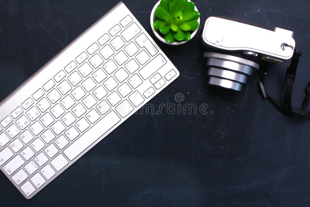 Computer Keyboard, Cactus and Camera Lie on Table Stock Photo - Image ...