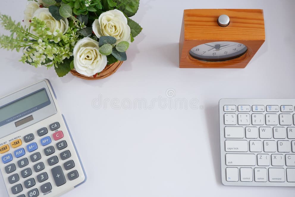 Computer Keyboard with Calculator and Flowerpot on White Desk, with ...