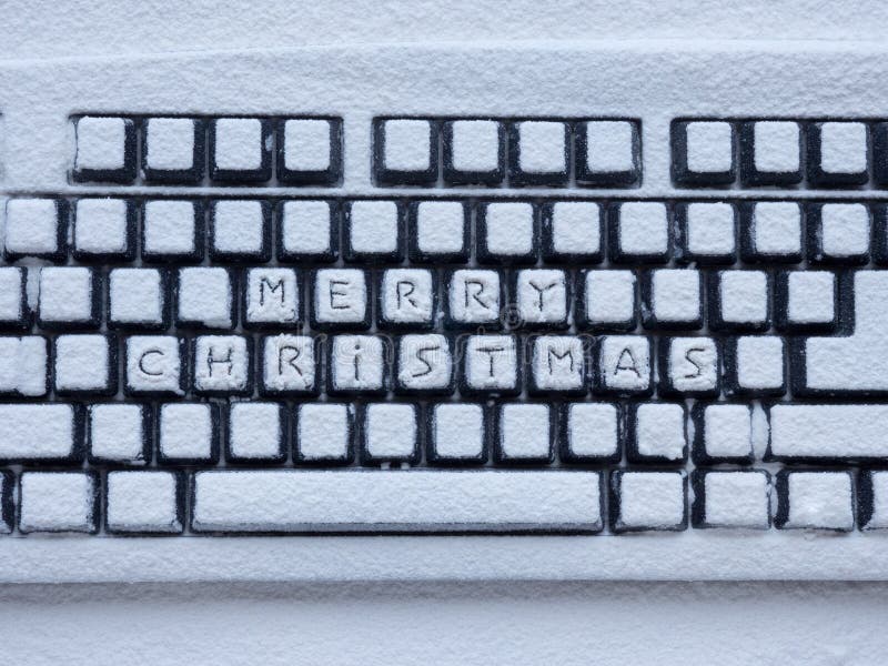 Computer Keyboard Covered with White Snow with Inscription Merry ...