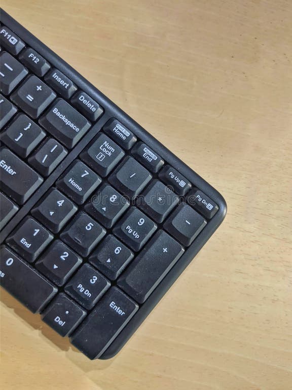 A Computer Keyboard on a Cream-colored Table with Black and White ...