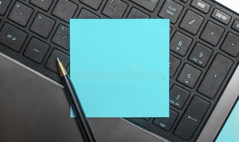 On a Computer Keyboard, a Pen and a Blue Sticker with Space To Insert ...