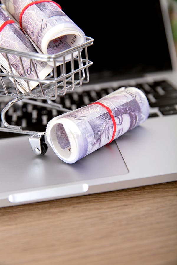 On the Computer Keyboard is a Small Shopping Cart Full of Pound ...
