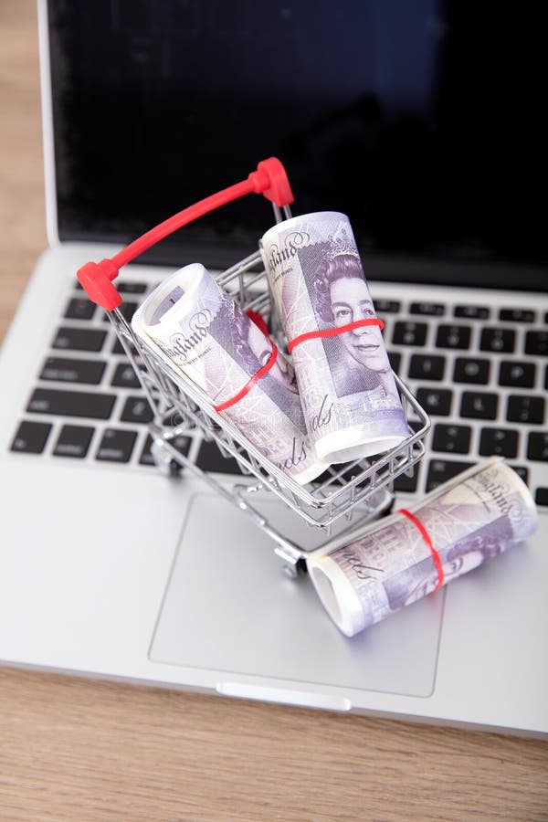 On the Computer Keyboard is a Small Shopping Cart Full of Pound ...