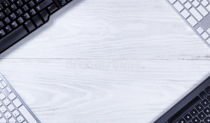 Computer Keyboards on All Corners of White Desktop Stock Photo - Image ...