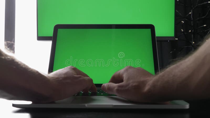 Chroma Key Green Screen. Man is Working on Laptop Computer with Green ...
