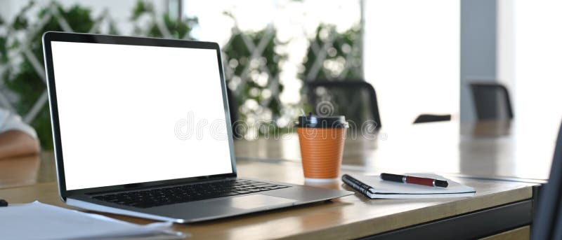 Computer Laptop with a White Blank Screen is Putting on a Meeting Table ...