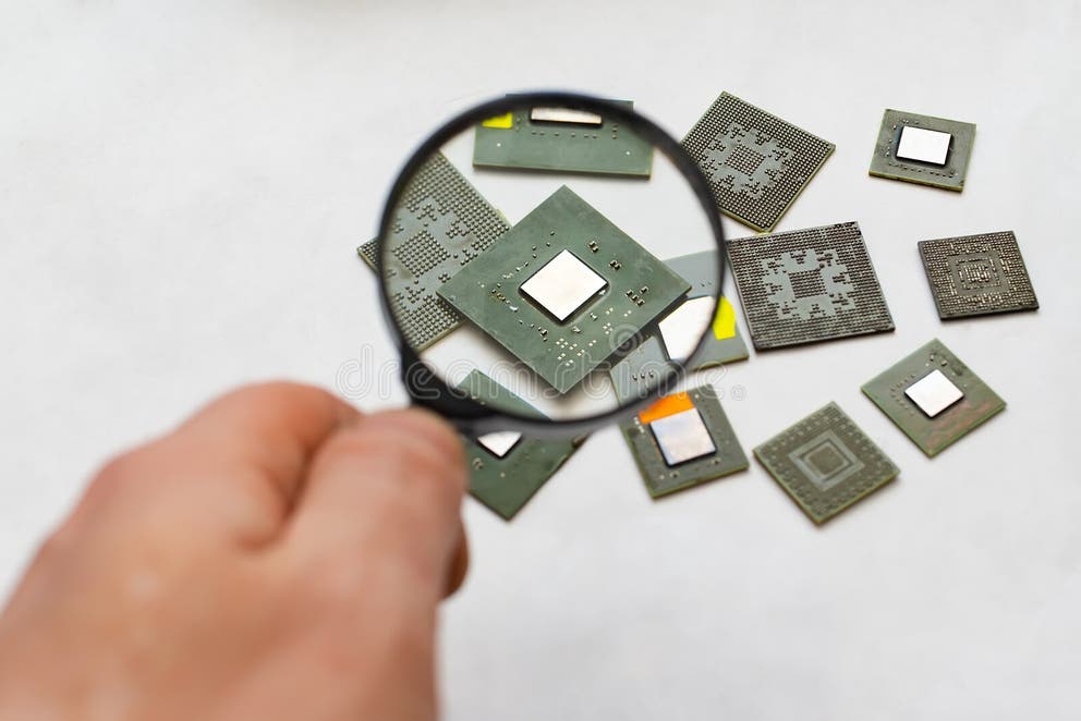 Computer Microprocessor that a Person Views through a Magnifying Glass ...