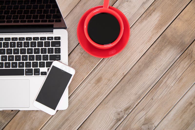 Computer and Mobile Phone and a Cup of Coffee on the Table Editorial ...