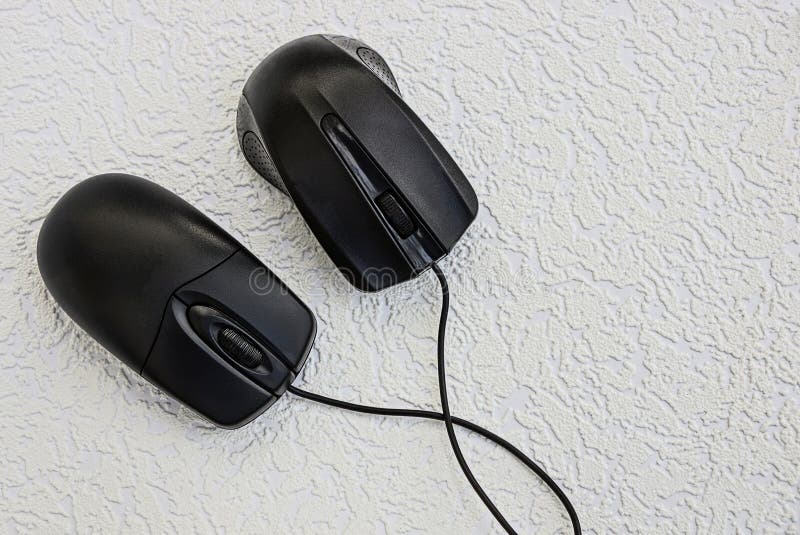 Two Black Computer Mice with a Wire on a Gray Surface Stock Photo ...