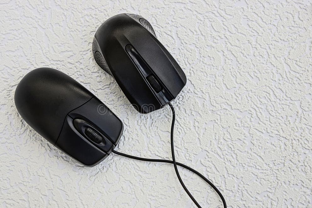 Two Black Computer Mice with a Wire on a Gray Surface Stock Photo ...
