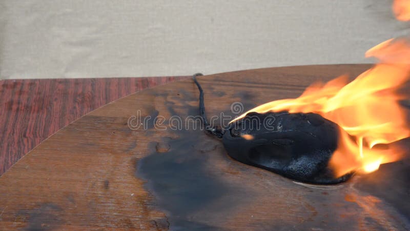A Computer Mouse on Fire on a Black Surface Stock Footage - Video of ...