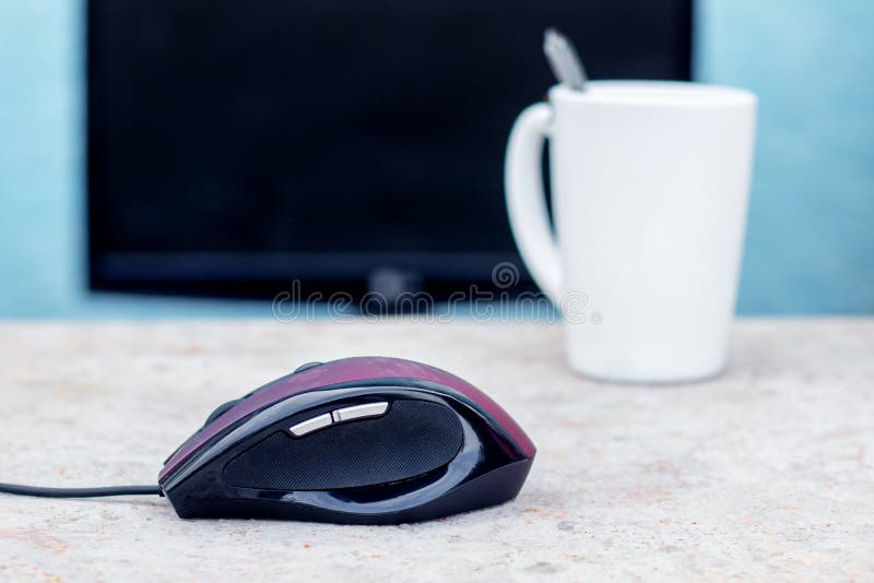 A Computer Mouse and a Mug of Tea Near the Computer Stock Photo - Image ...