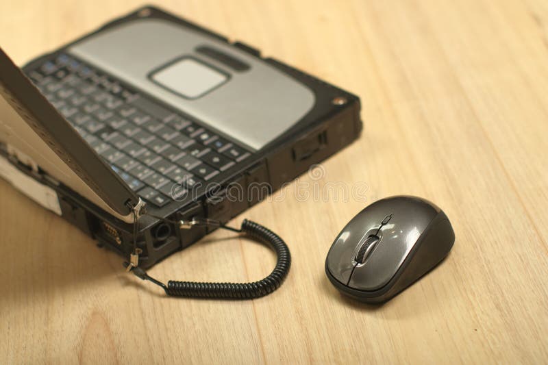 A Computer Mouse Next To a Laptop Stock Image - Image of next, outside ...