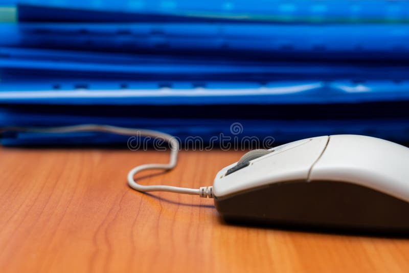 Computer Mouse and Blue Files Arranged on Desk on a Workday Stock Photo ...
