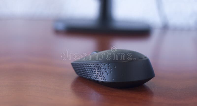 Computer Mouse on the Table. Black Color. on a Wooden Background Stock ...