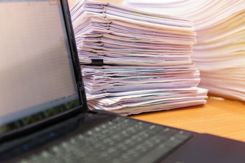 Computer Notebook and Documents on Desk Stack Up High Waiting To Stock ...