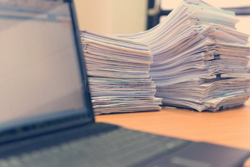 Computer Notebook and Documents on Desk Stack Up High Waiting To Stock ...