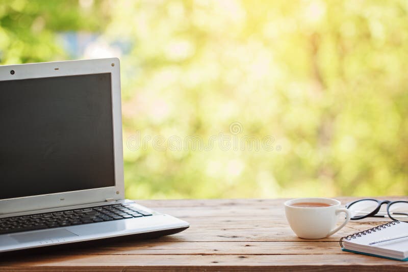 Computer with Notebook, Glasses and Cup of Tea or Coffee on Wooden ...