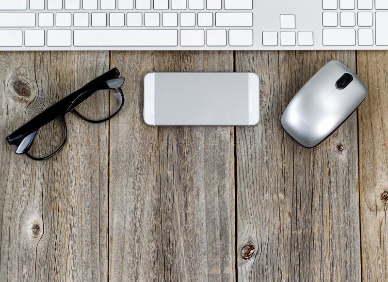 Computer Peripherals and Reading Glasses on Rustic Wooden Desktop Stock ...