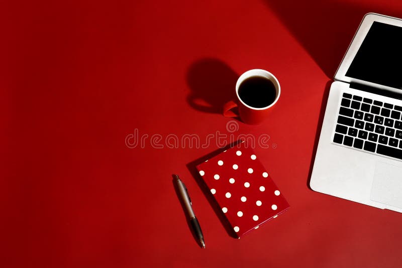 Computer on a Red Table with a Red Book a Red Coffee Cup and a Pen ...