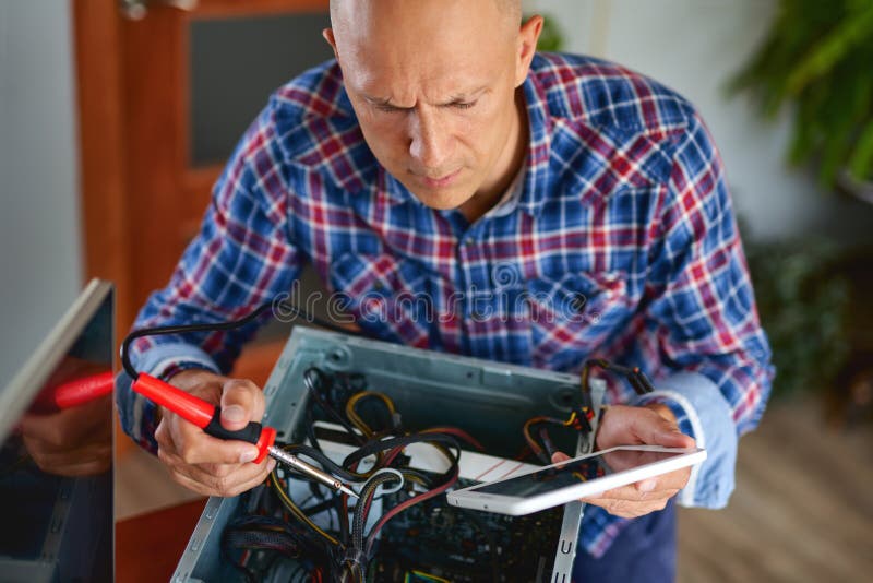 Man repairing computer stock image. Image of device - 179535379