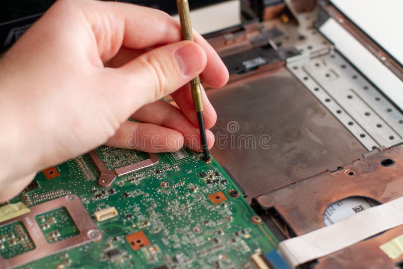 Computer Repair Technician Working on Motherboard with Screwdriver ...