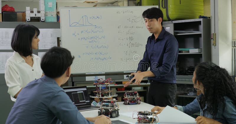 Asian Young Electronics Engineer Building, Fixing Robotics in ...