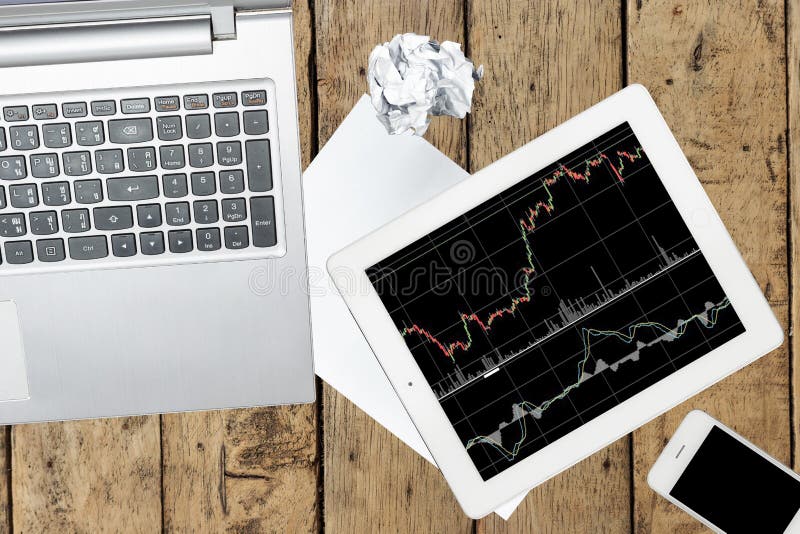 Computer, Smartphone, Tablet with Graph and Paper on Wood Table Stock ...