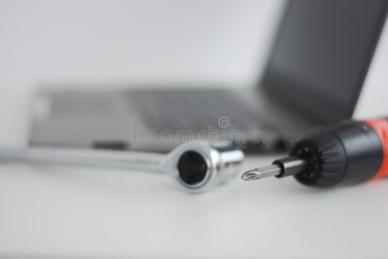 Computer Support with Out of Focus Notebook and Screwdriver Stock Photo ...