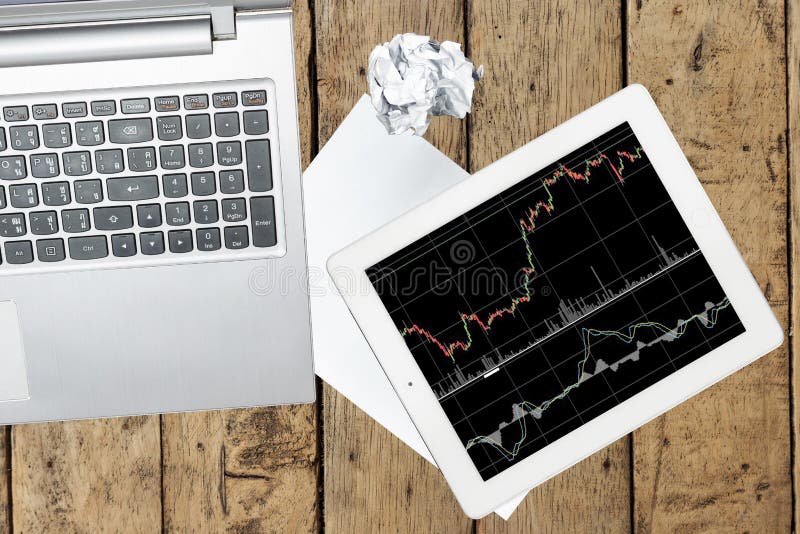 Computer, Tablet with Graph and Paper on Wood Table Stock Image - Image ...