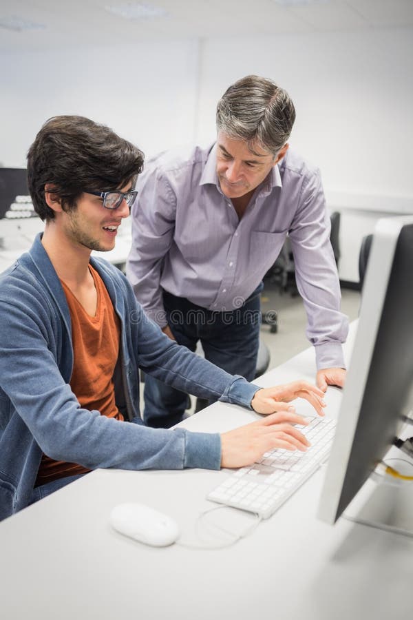 Professor Assisting a Student with Studies Stock Image - Image of ...