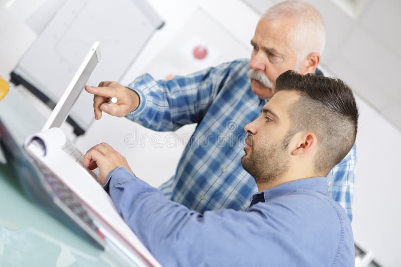 Computer Teacher Assisting Student Stock Image - Image of classroom ...
