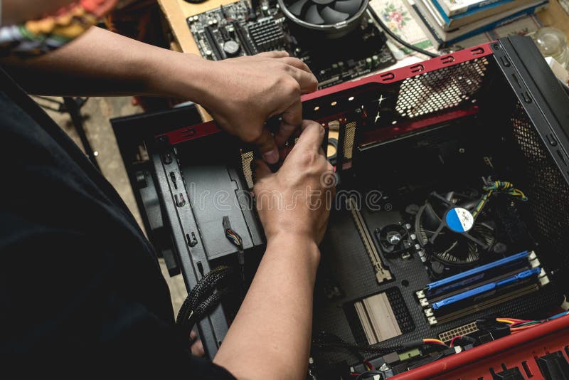 A Computer Technician Assembles a Desktop Computer with New Parts ...