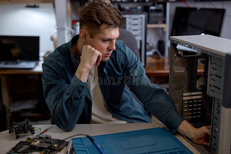 Computer Technician Checking a Computer Component after Disassembling ...