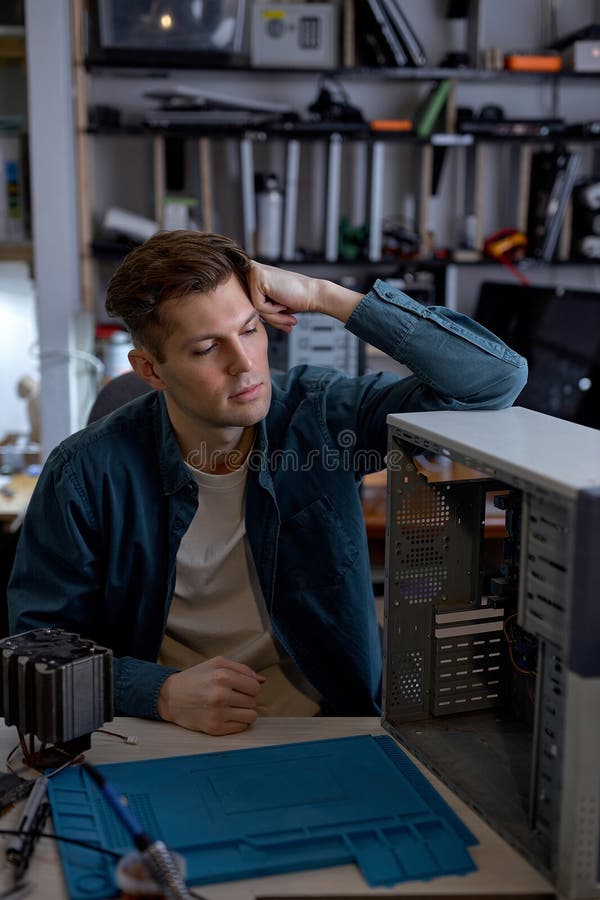Computer Technician Checking a Computer Component after Disassembling ...